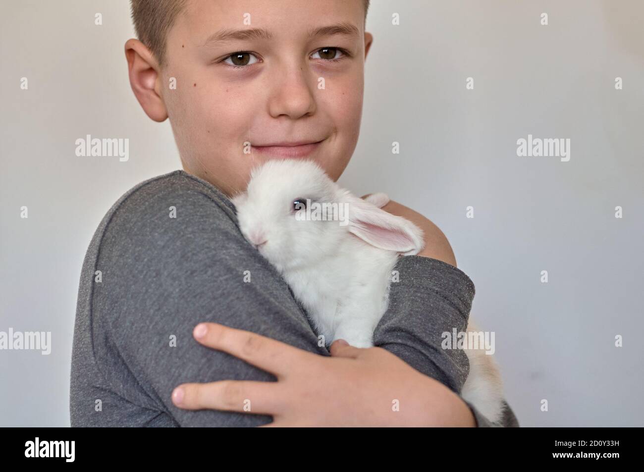 a boy with a white rabbit in his hands Stock Photo - Alamy