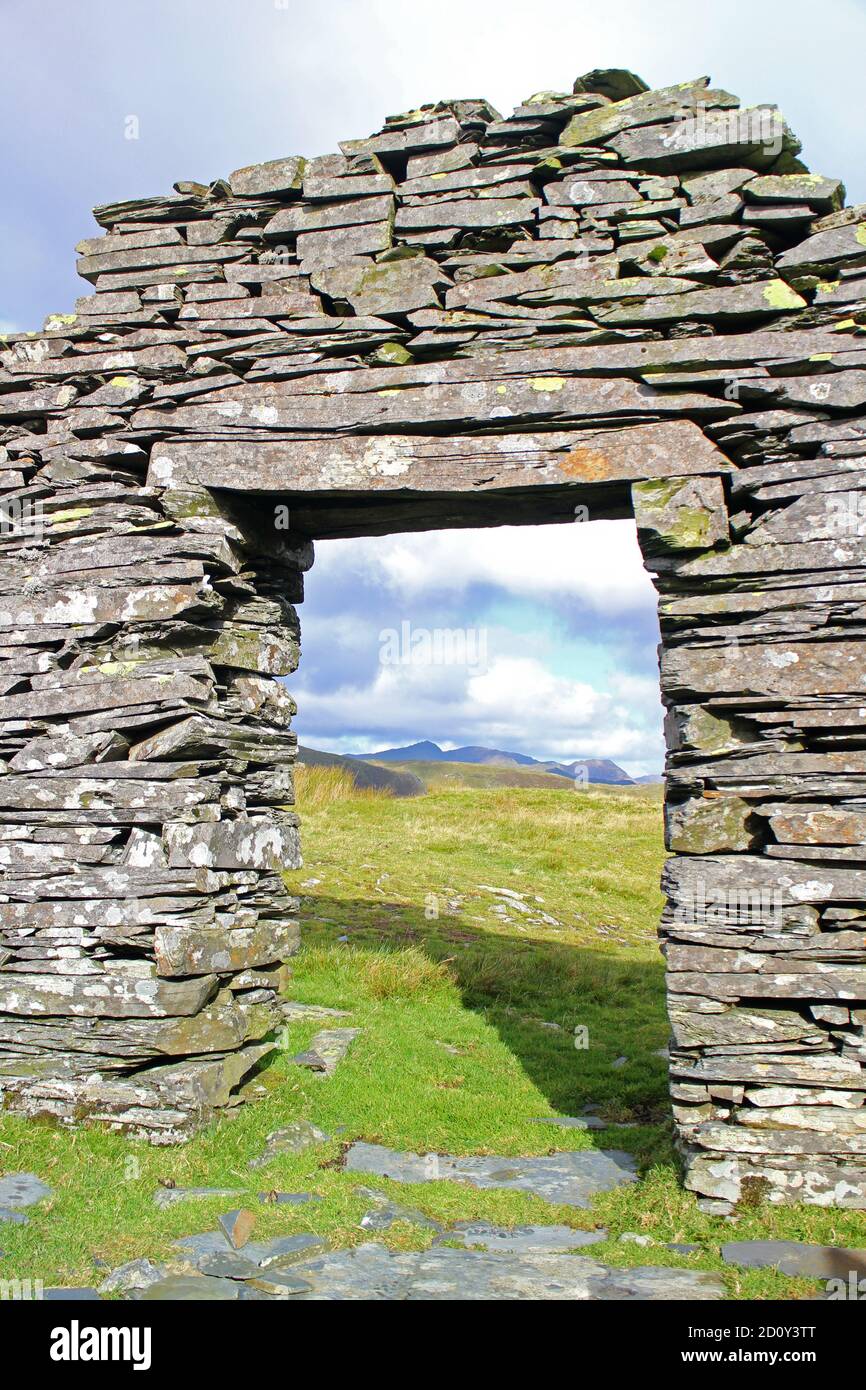 Snowdon framed in doorway of derelict slate quarry building, Moelwyn ...