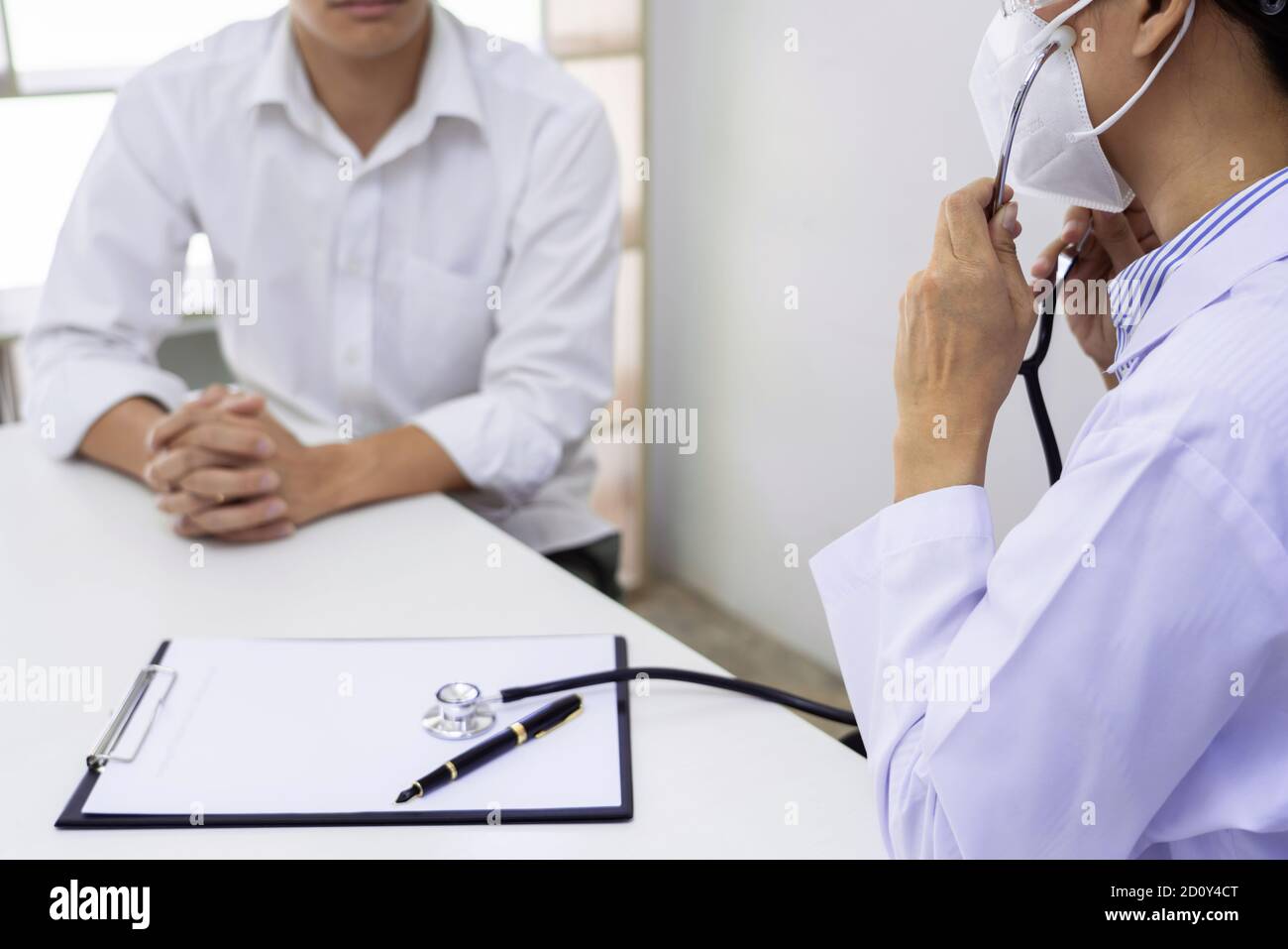 patient listening intently to doctor explaining symptoms medical ...