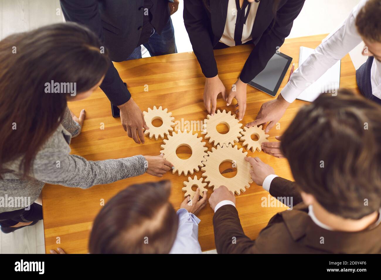 Startup team joining cogwheels as metaphor for teamwork, management and ...