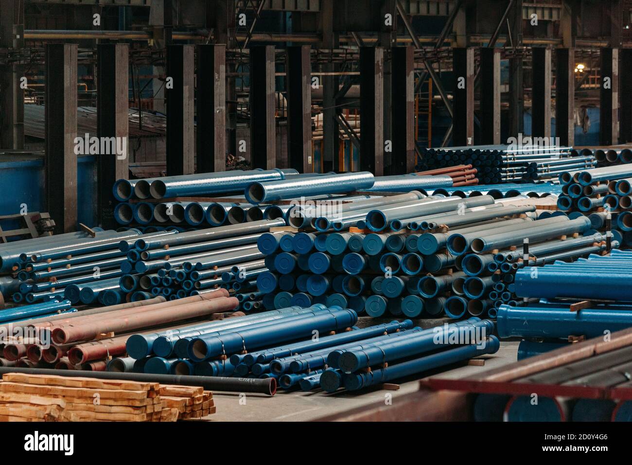New cast iron pipes for pipeline construction in warehouse Stock Photo ...