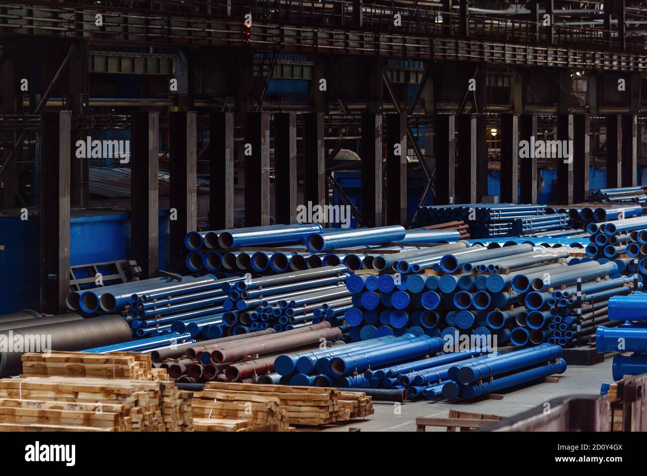 New cast iron pipes for pipeline construction in warehouse Stock Photo ...