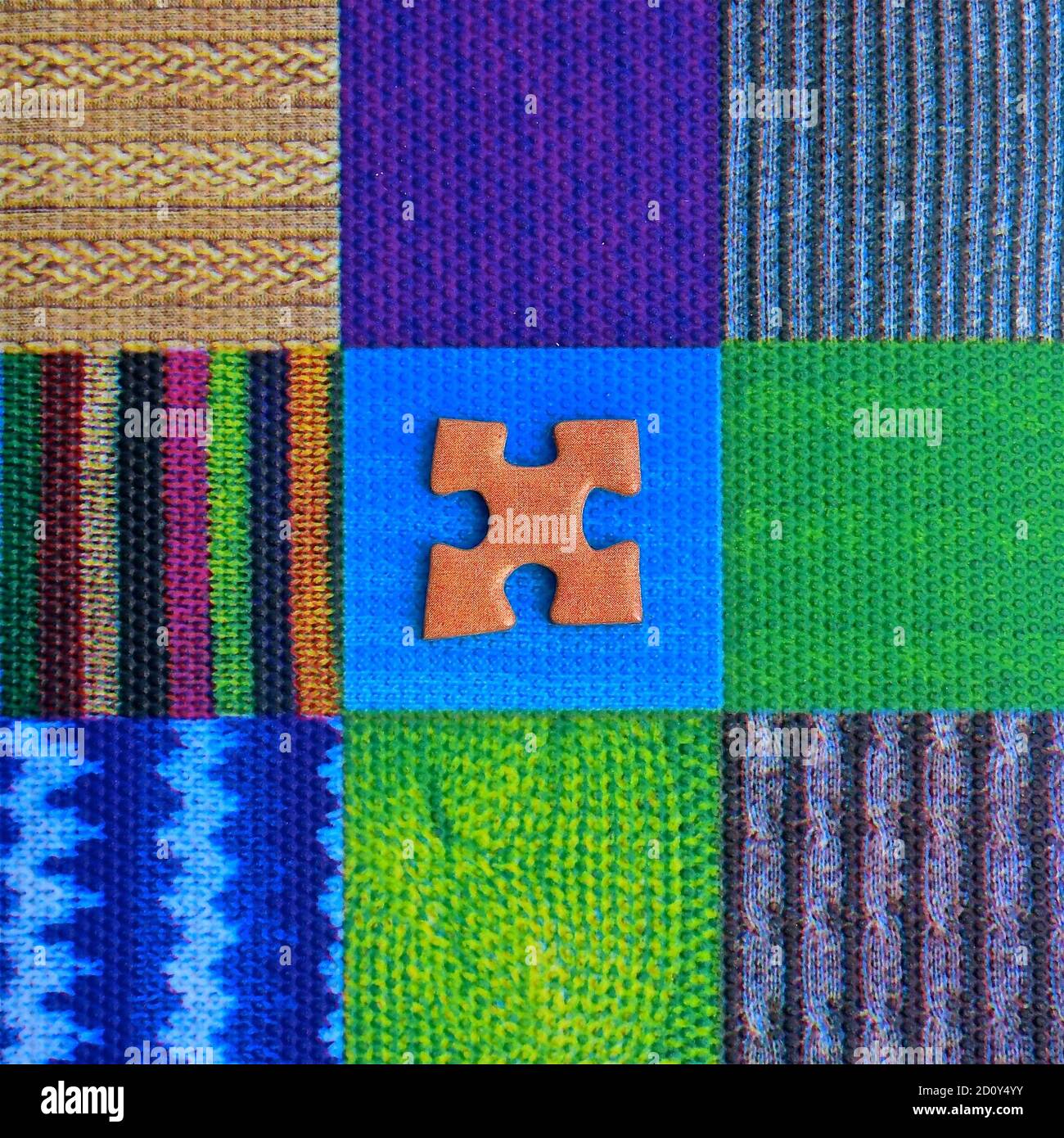 A single jigsaw piece in the centre of a grid of a mosaic of colourful ...