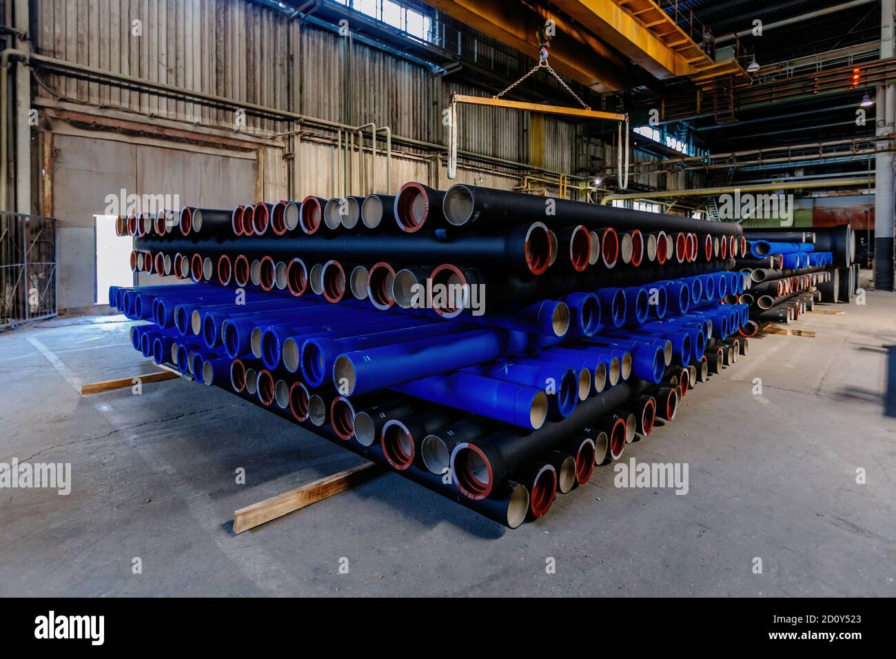 New cast iron pipes for pipeline construction in warehouse Stock Photo ...