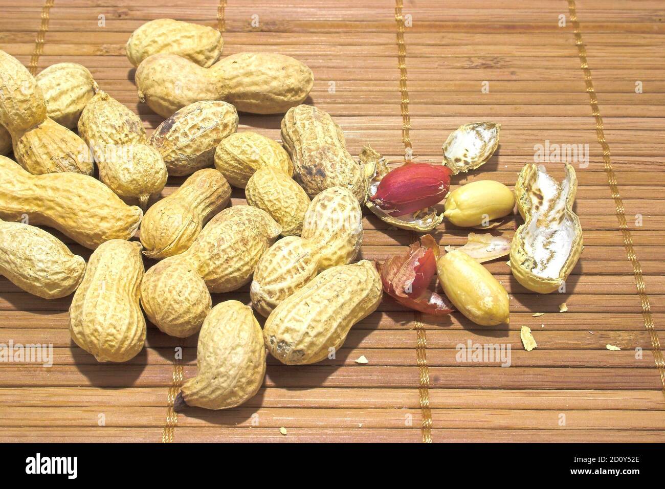 Peanuts on a brown bamboo background Stock Photo - Alamy