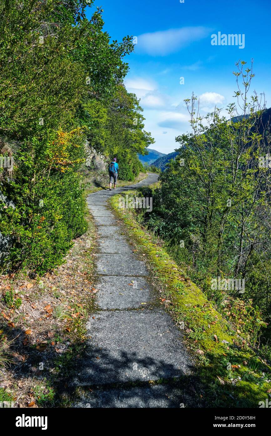 Solitary female walker, hiker, on the old aqueduct that provided power ...