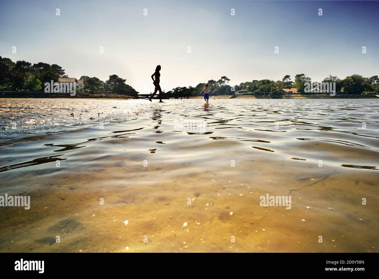 Backlit people bathing in Hossegor's lake in Landes, France Stock Photo ...
