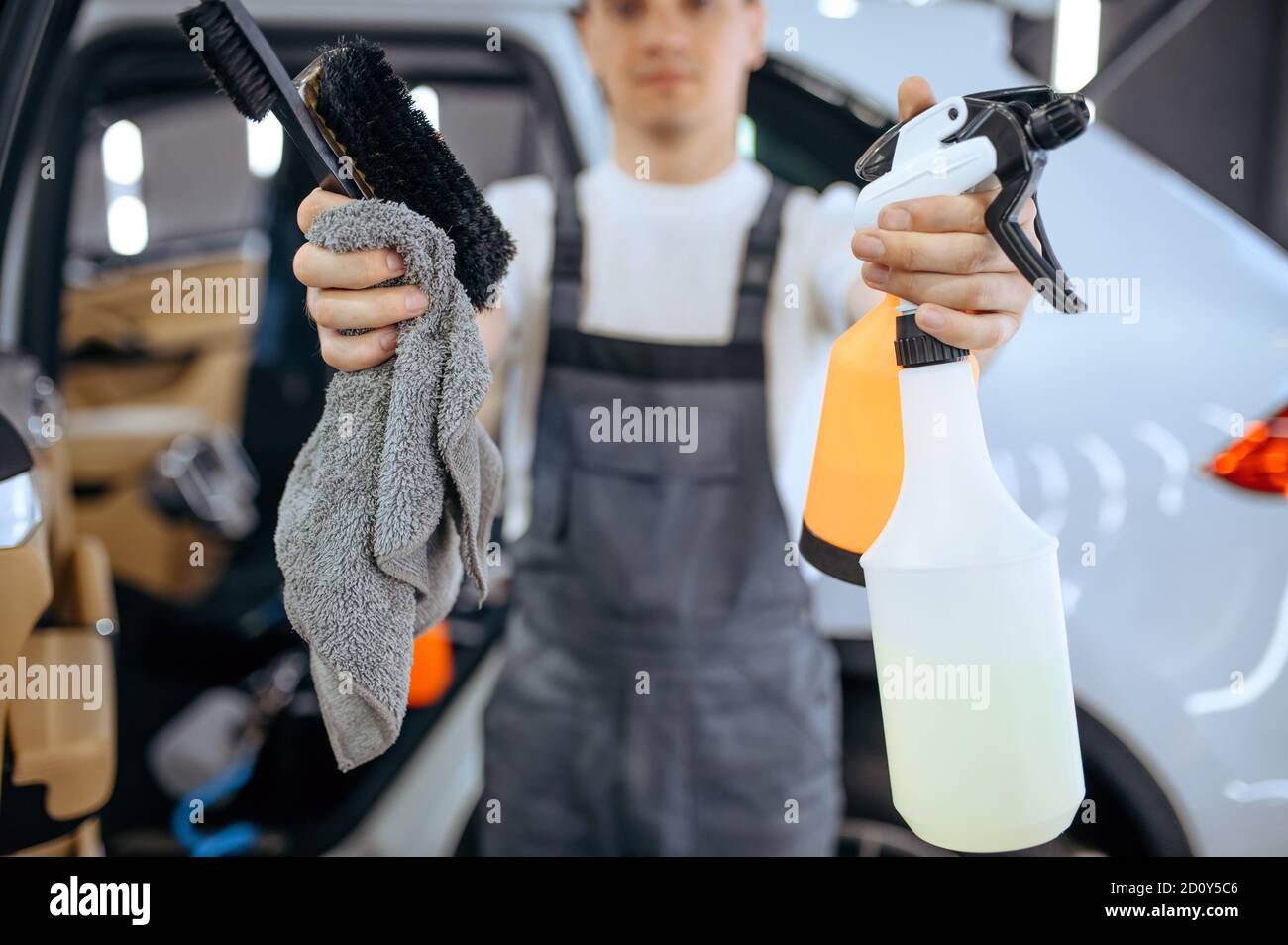 Worker shows tools for dry cleaning and detailing Stock Photo - Alamy
