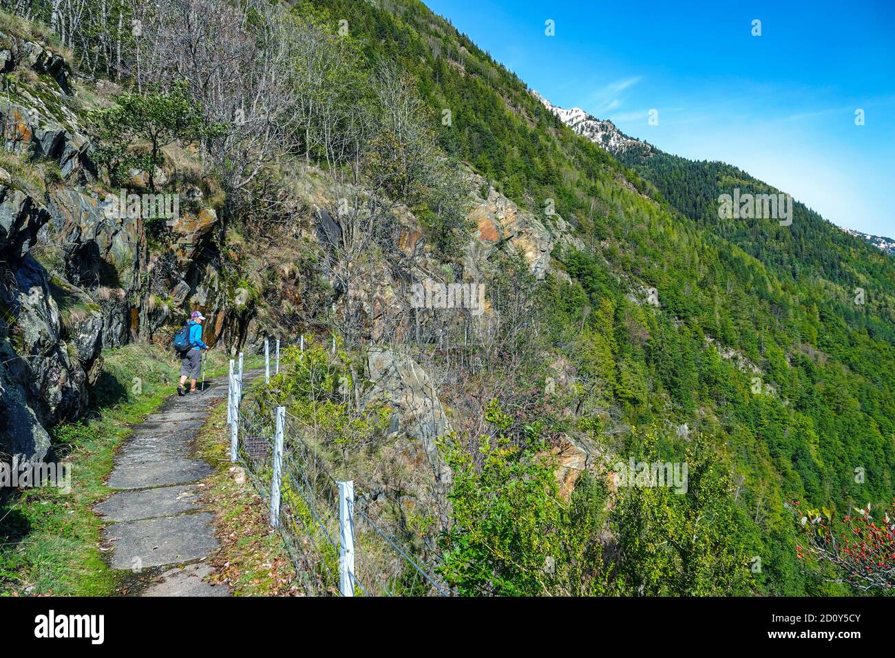 Solitary female walker, hiker, on the old aqueduct that provided power ...