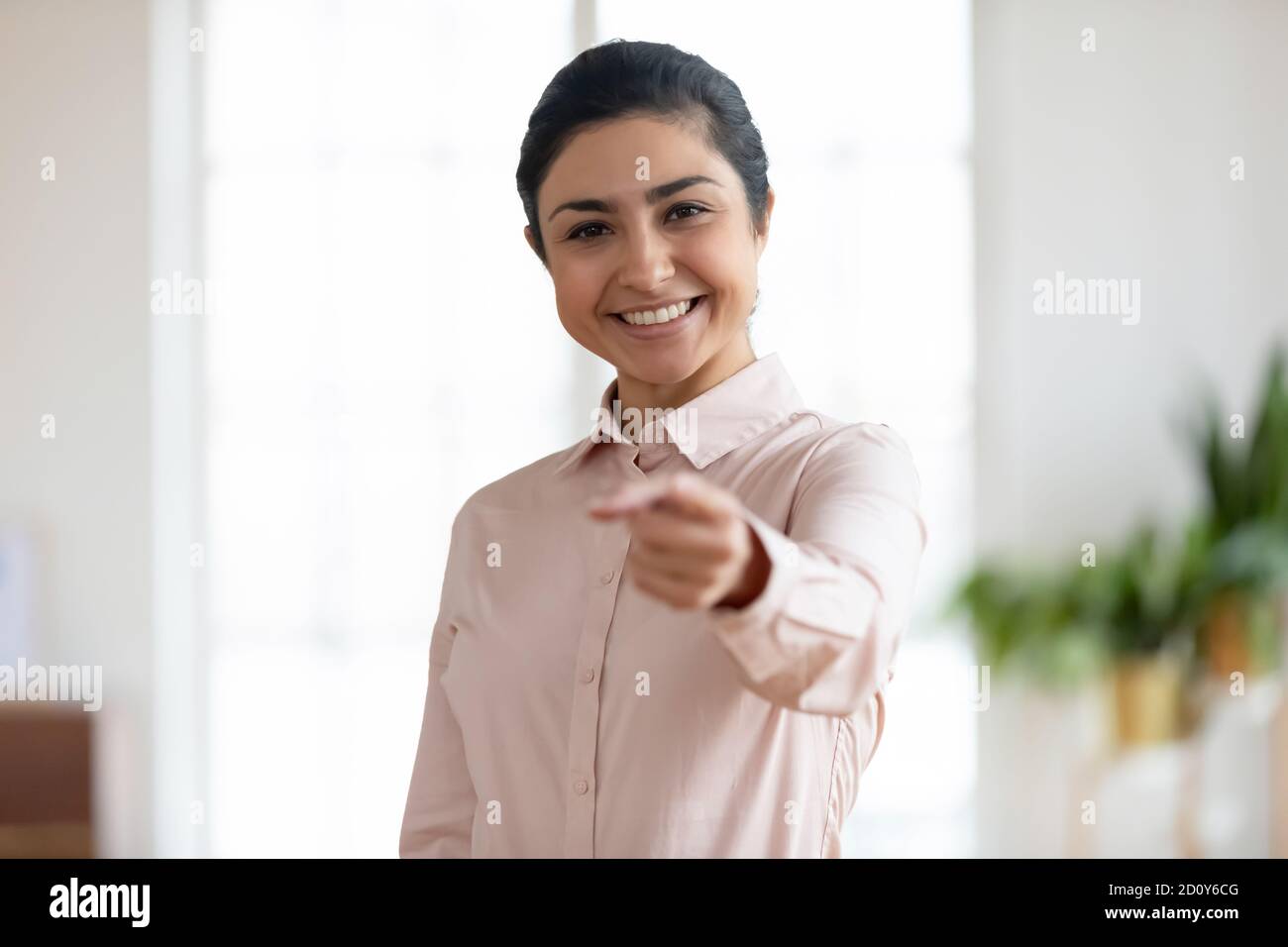 Portrait of smiling indian woman point at screen Stock Photo - Alamy