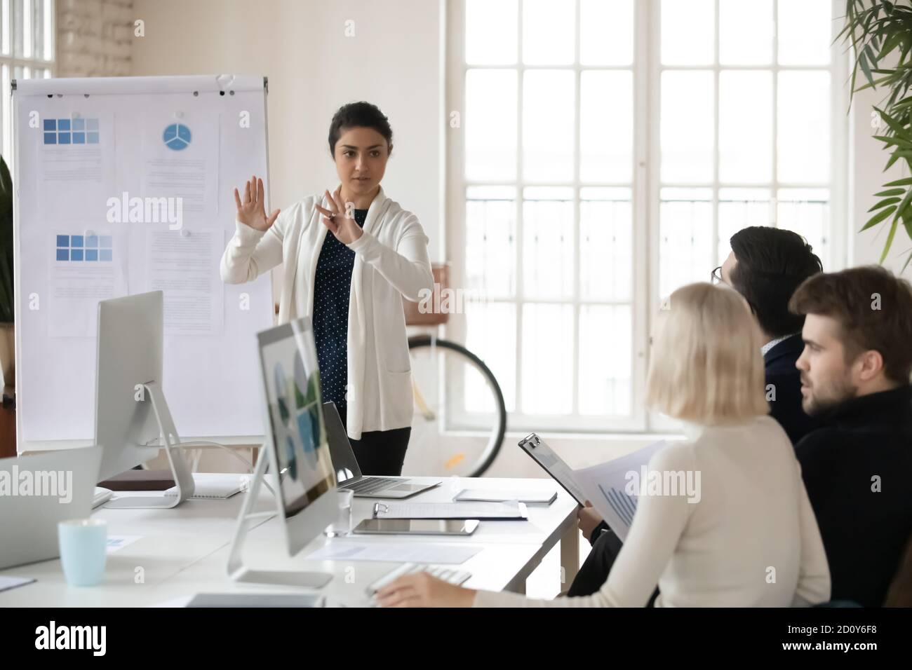 Confident indian female coach present project on whiteboard Stock Photo ...