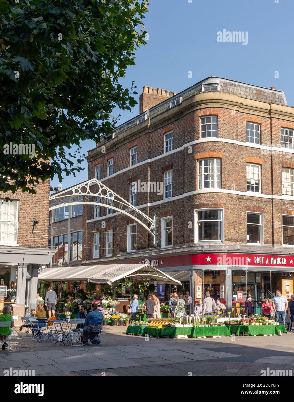 The entrance to York Market where people pass by a flower stall. People ...