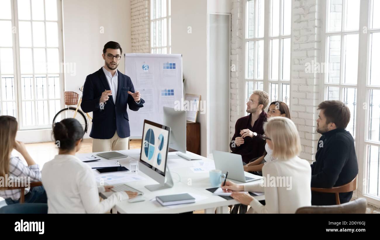 Confident male leader talk present project at meeting Stock Photo - Alamy