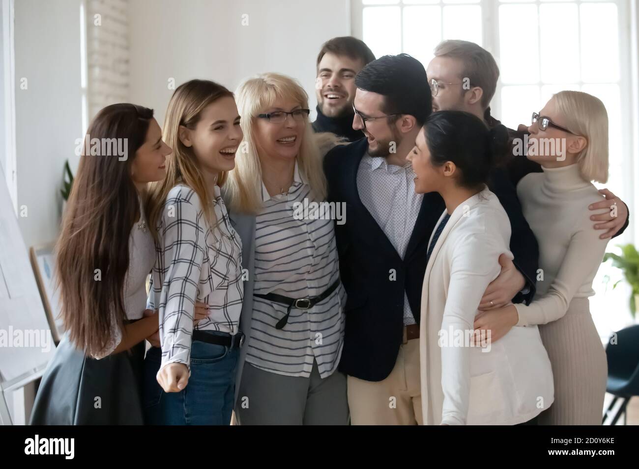 Excited colleagues have fun laugh at workplace Stock Photo - Alamy