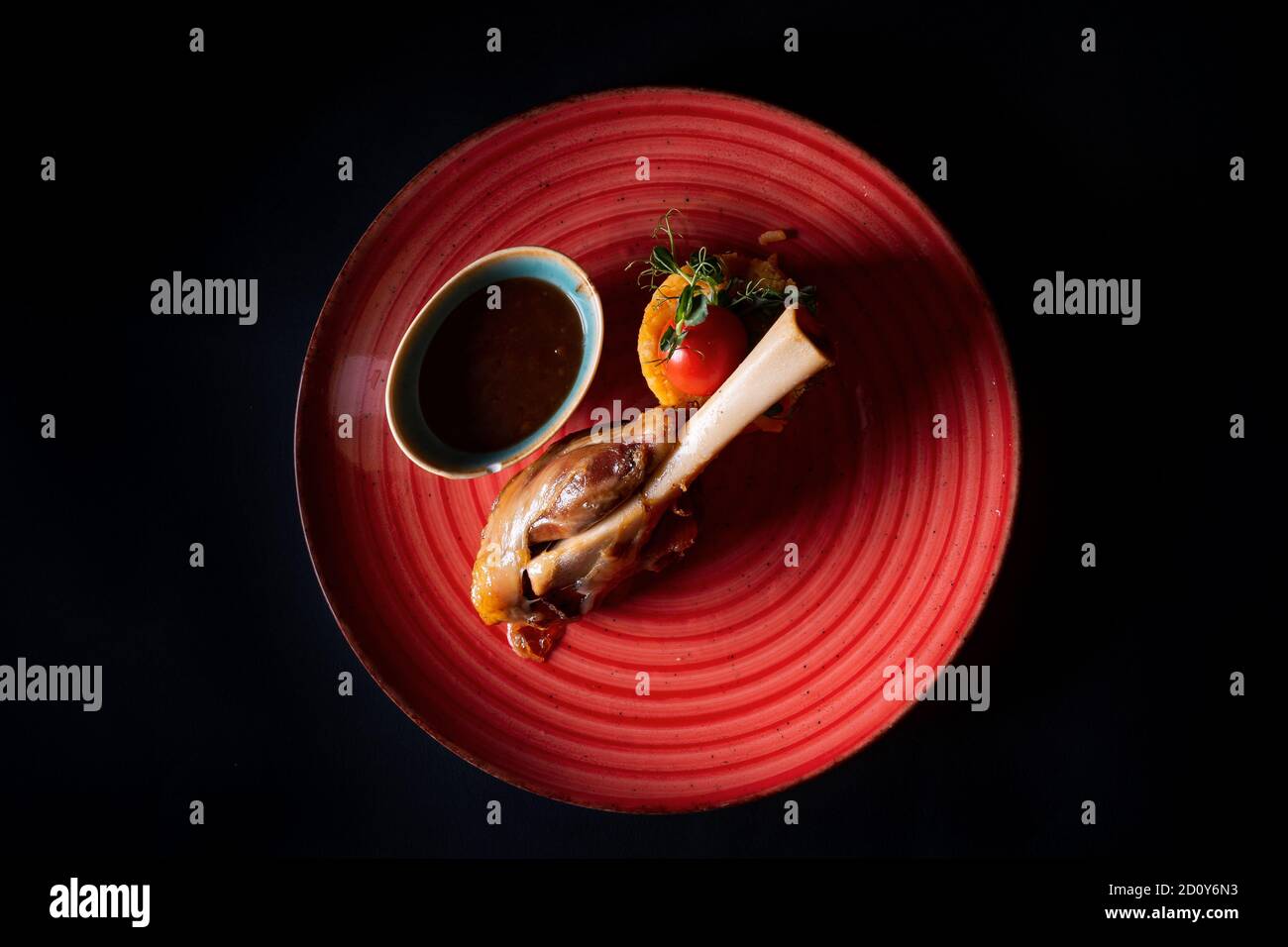 Top view of a lamb with sauce on black background Stock Photo - Alamy