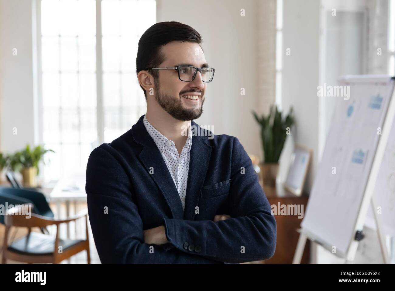 Smiling male employee look in distance dreaming or visualizing Stock ...
