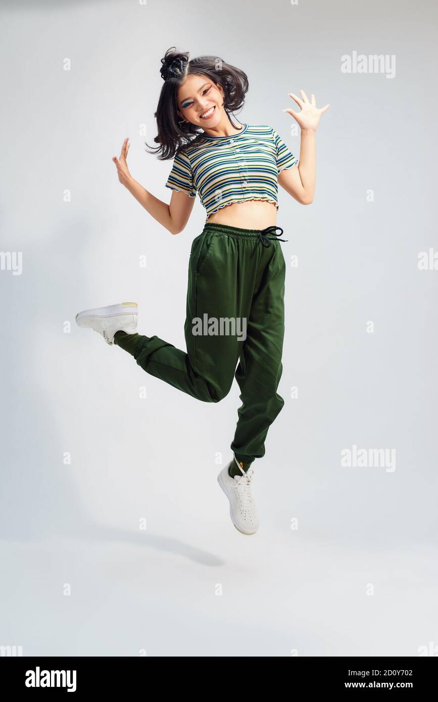 Full body photo of lovely girl raising hands arms jumping screaming ...