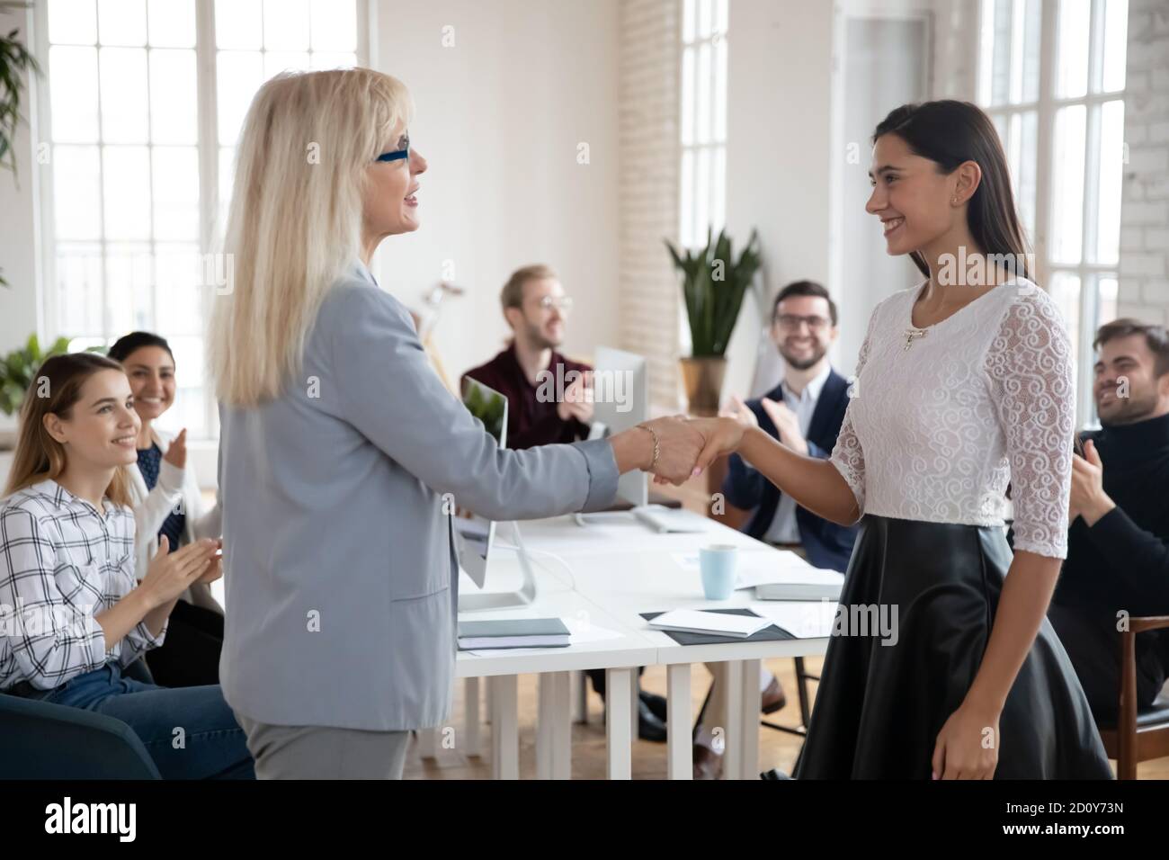 Businesswoman handshake greeting female colleague at meeting Stock ...
