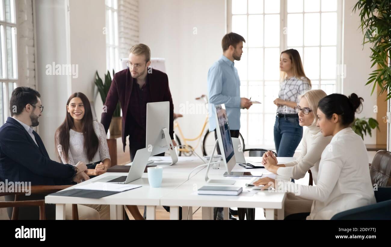 Diverse colleagues cooperate in shared office workplace Stock Photo - Alamy
