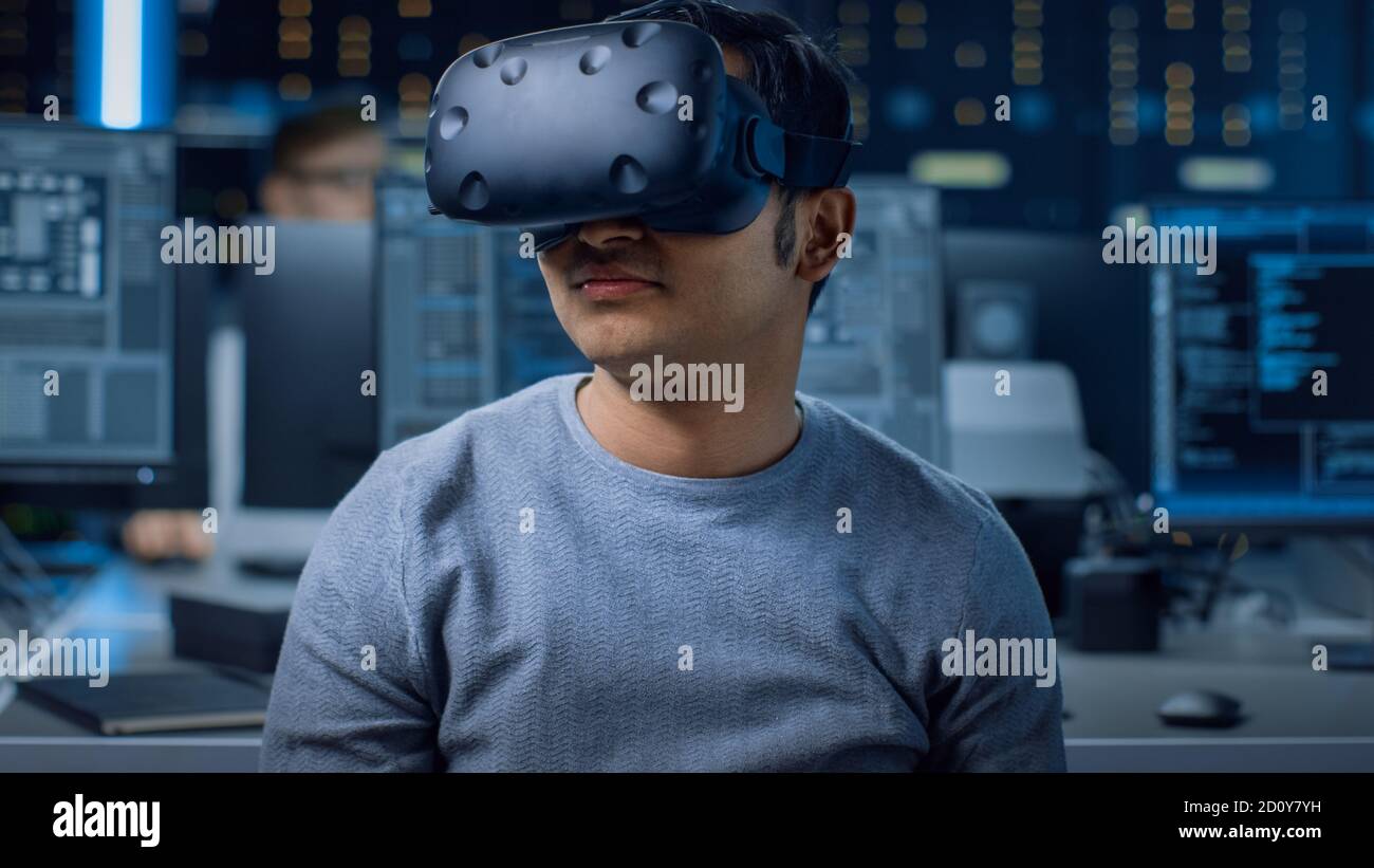 Software Delevoper Wearing Virtual Reality Headset Using Controllers to ...