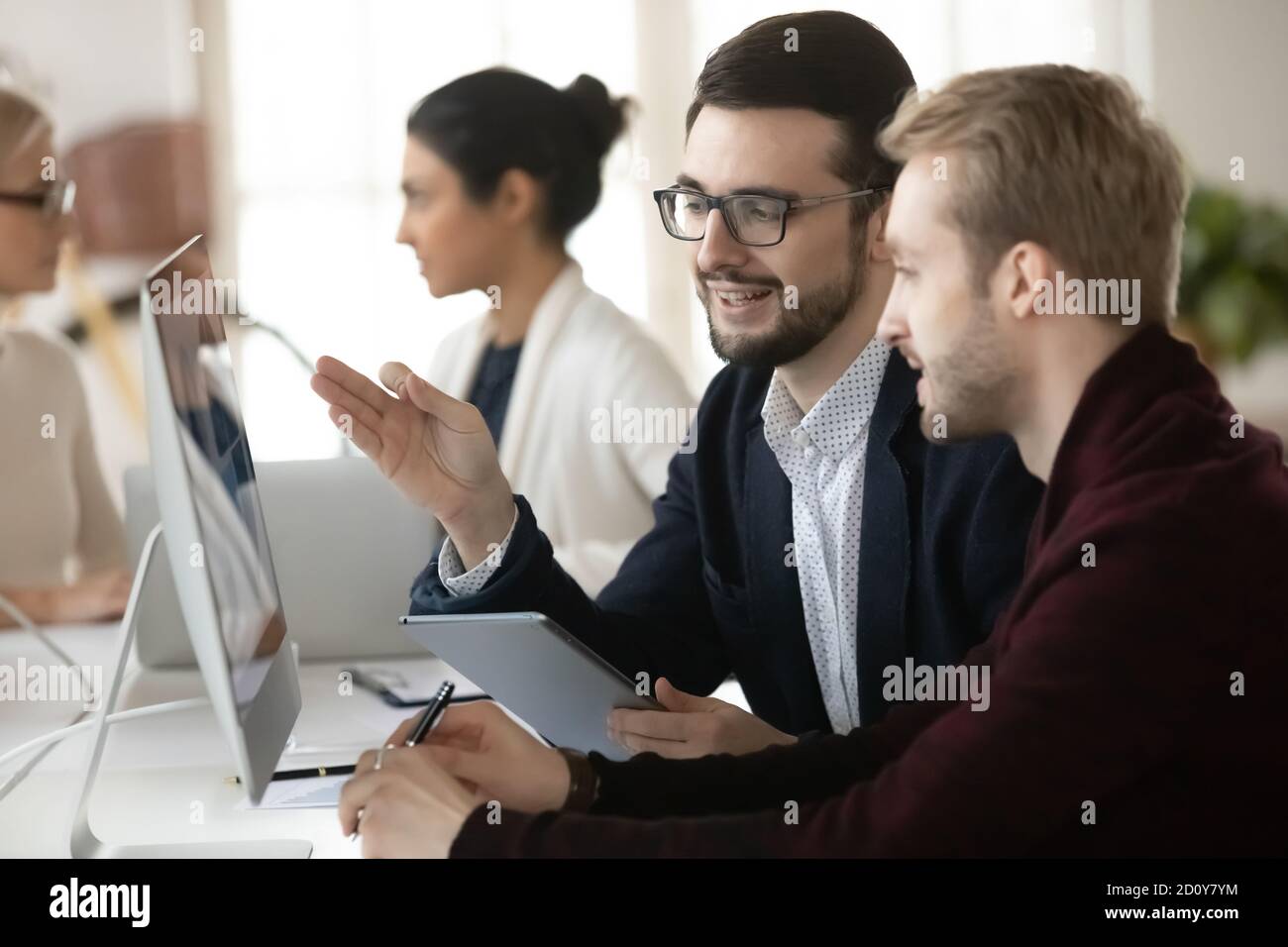 Diverse male colleagues collaborate in coworking office Stock Photo - Alamy
