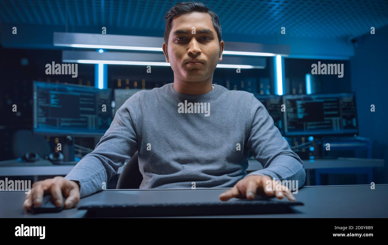 Portrait Of Software Programmer Sitting At His Desk And Working On Computer In Digital Identity