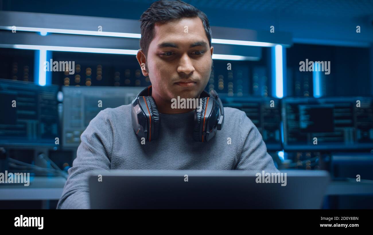 Portrait Of Software Developer Hacker Programmer Sitting At His Desk