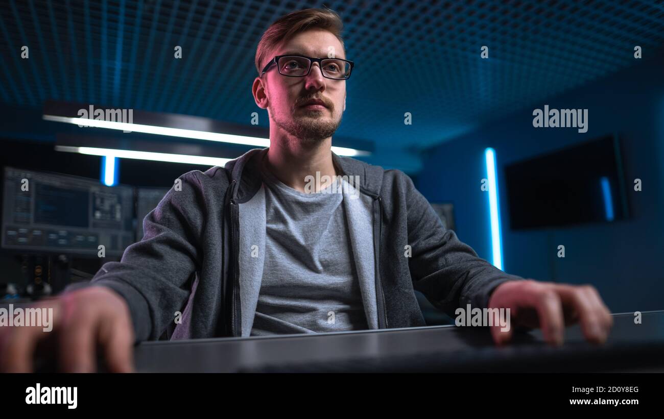 Low Angle Portrait Shot of Software Developer Hacker Wearing Glasses ...