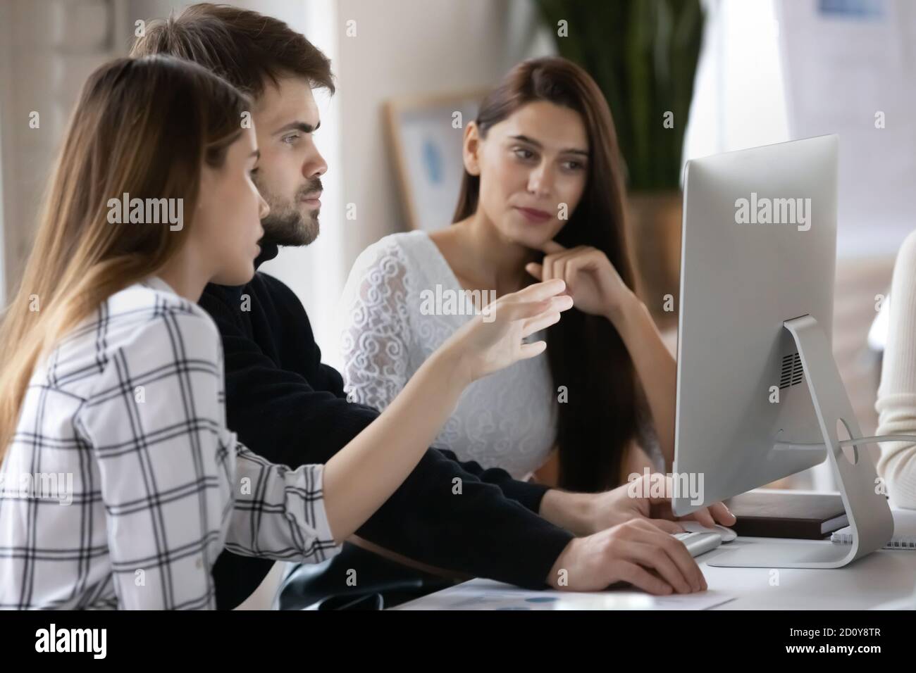 Focused colleagues collaborate in office using PC Stock Photo - Alamy