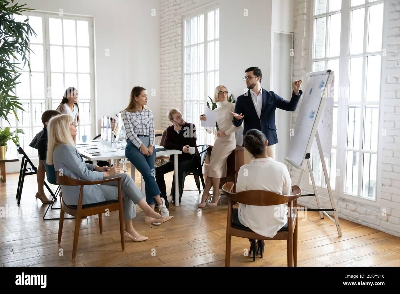 Confident businessman present company project on flip chart Stock Photo ...