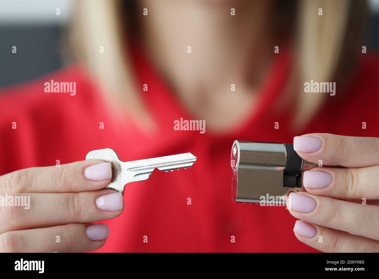 Female hands hold the metal core of lock and key closeup Stock Photo ...