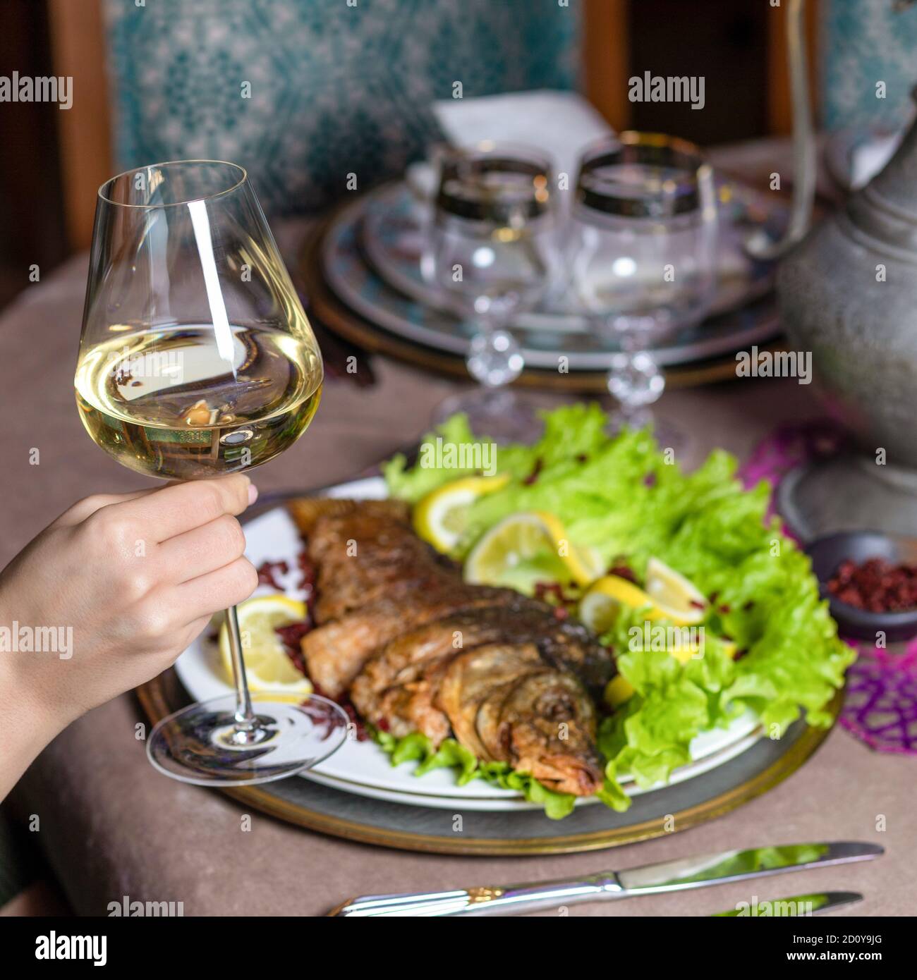 Woman serving seafood plate hi-res stock photography and images - Alamy