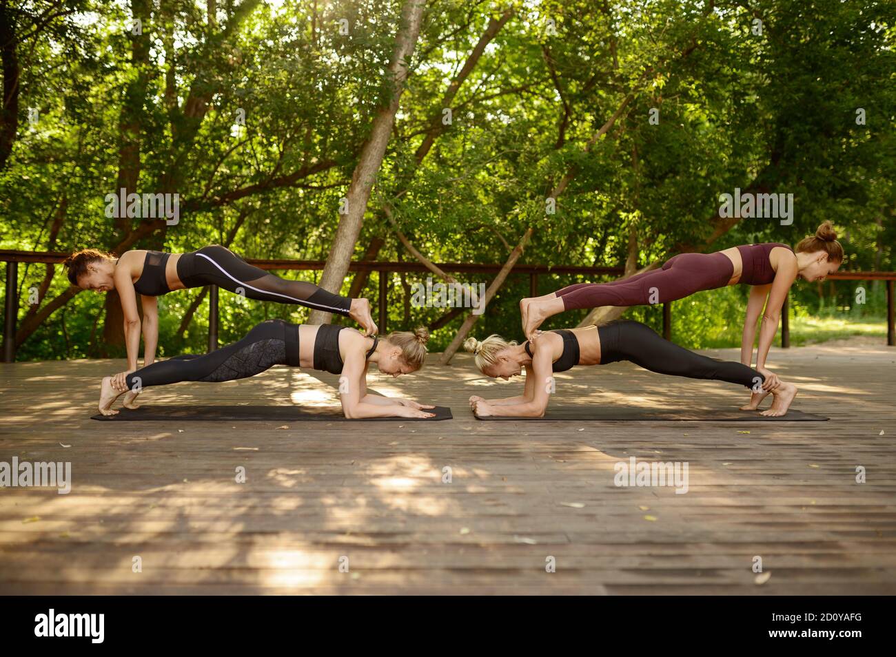 Four women doing balance exercise, group yoga Stock Photo - Alamy