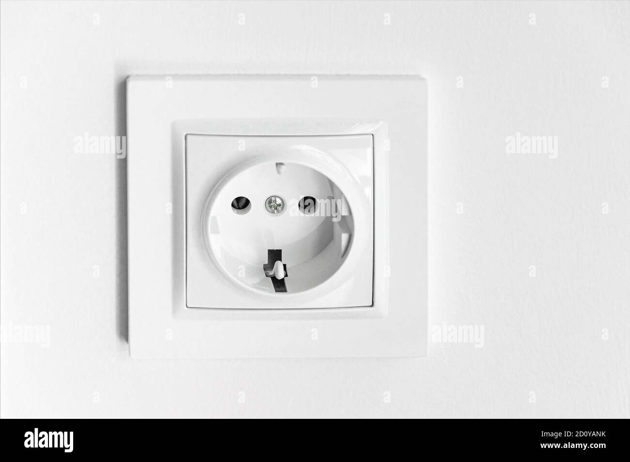 The white plastic socket is mounted in a white wall Stock Photo - Alamy
