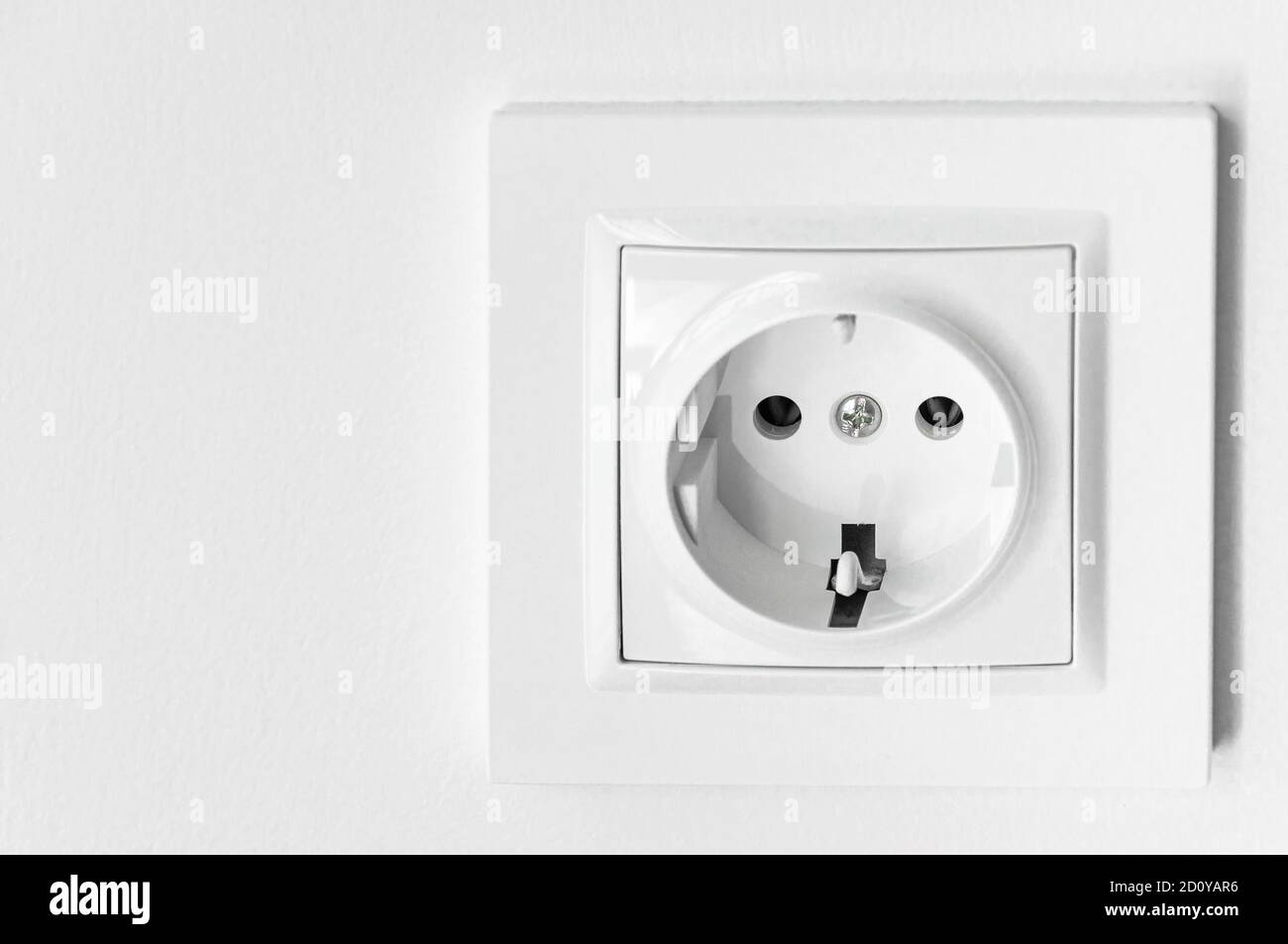 The white plastic socket is mounted in a white wall Stock Photo - Alamy
