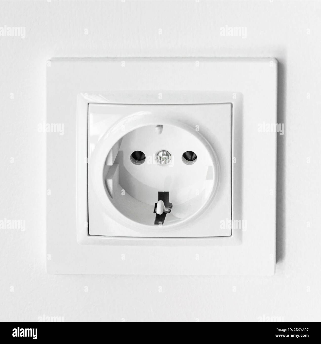 The white plastic socket is mounted in a white wall Stock Photo - Alamy