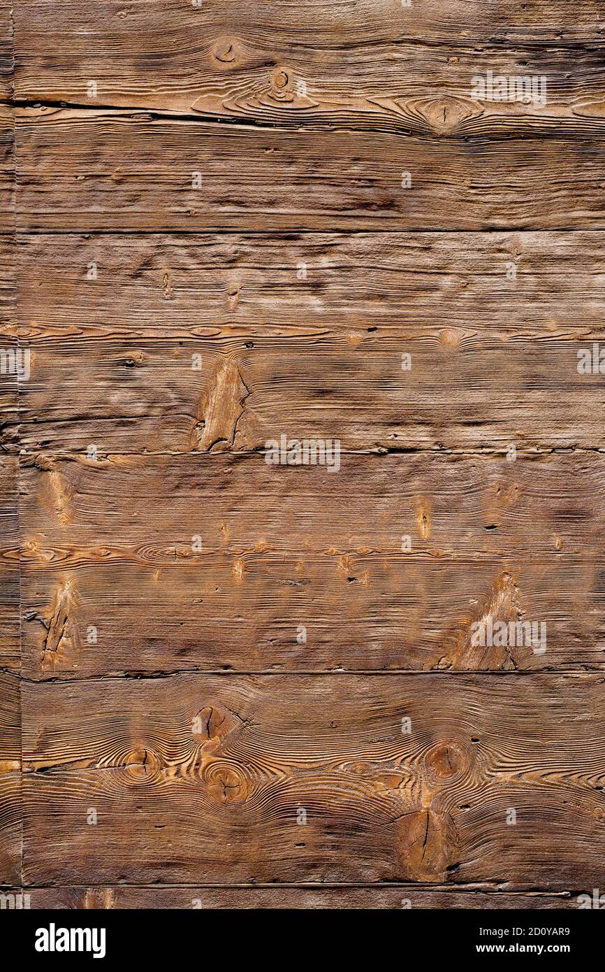 The rough texture of brown wooden horizontal planks with deep grooves ...