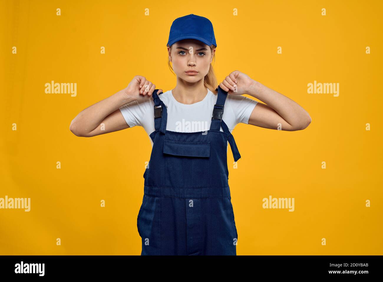 Woman in working uniform blue cap delivering courier service yellow ...