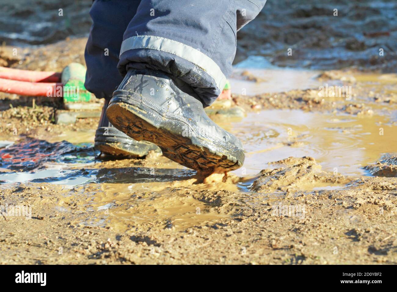 boy with rubber boots in a puddle Stock Photo - Alamy