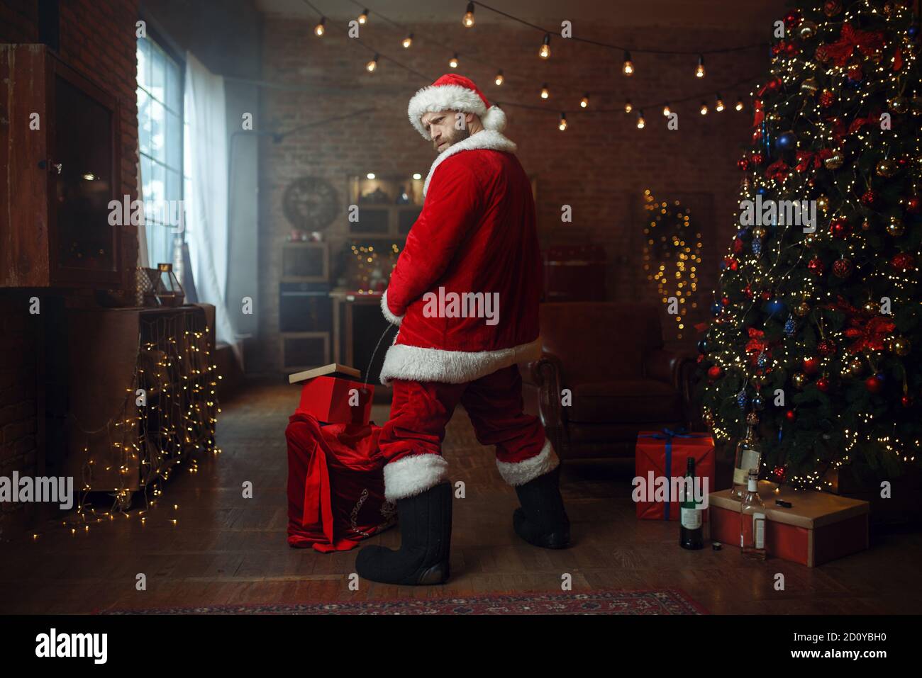 Bad drunk Santa claus pee on gifts Stock Photo - Alamy