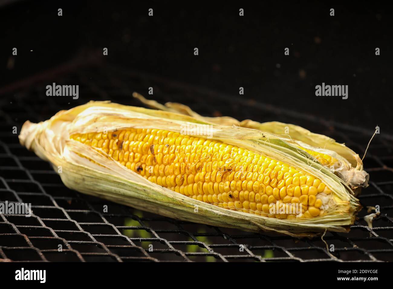 Yellow corn cooked on a grill. Preparing healthy food. Cooking outside ...