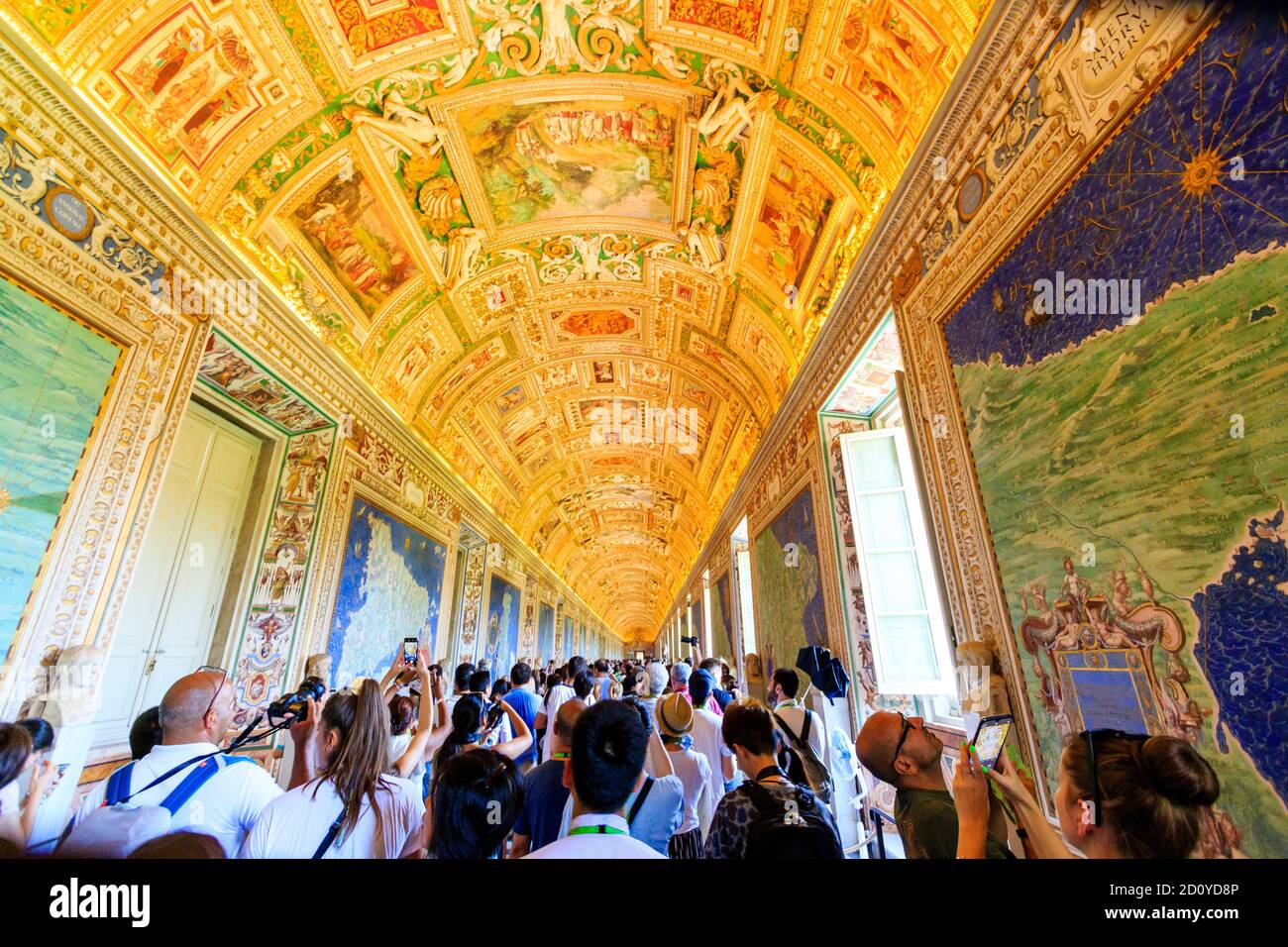 People crowded into the Gallery of Maps at the Vatican Museum. Wide angle view showing the ...