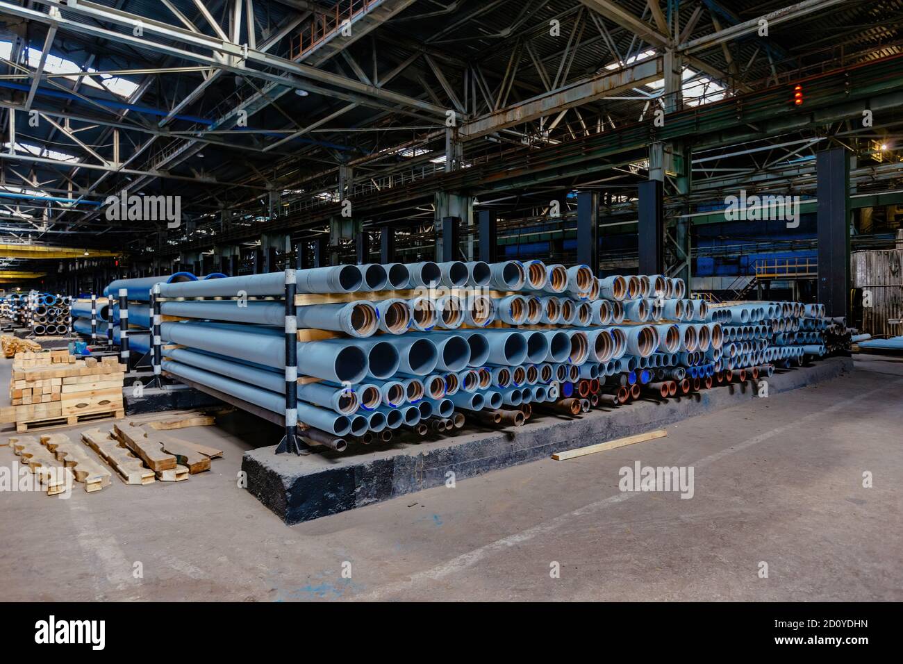 New cast iron pipes for pipeline construction in warehouse Stock Photo ...