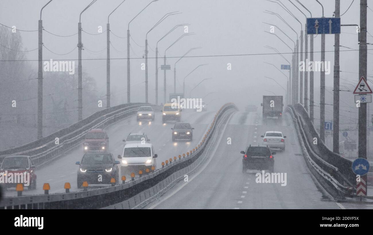 Wet snow with rain on a city street Stock Photo - Alamy