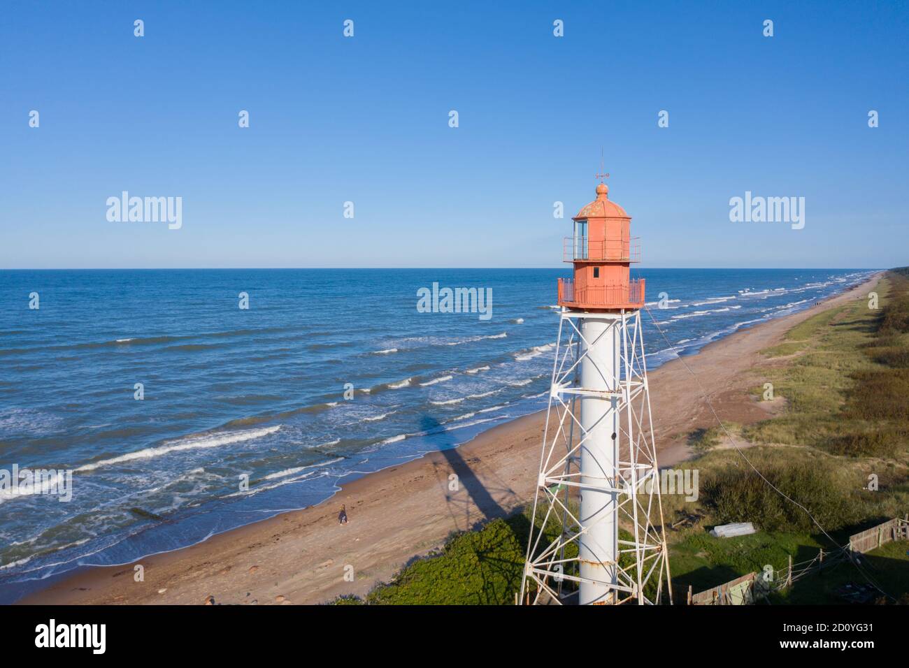 Aerial view of lighthouse with red top and white base. Blue sky and sea ...