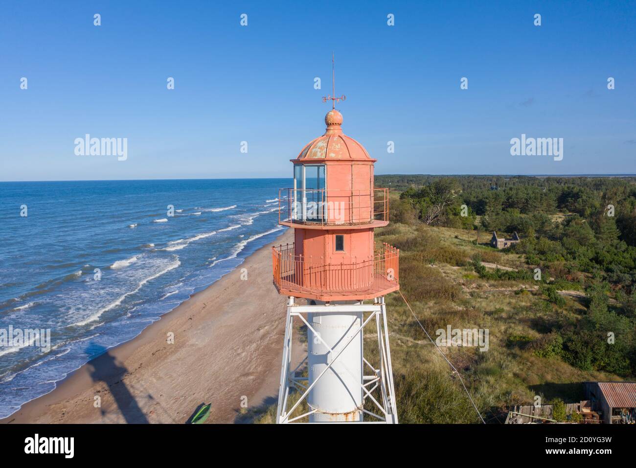 Aerial view of lighthouse with red top and white base. Blue sky and sea ...