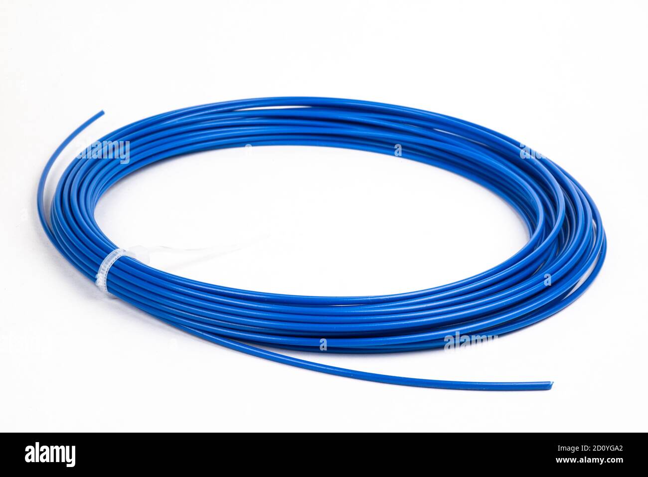 Top view of blue rolled filament 3D pen PLA isolated on white. Closeup ...
