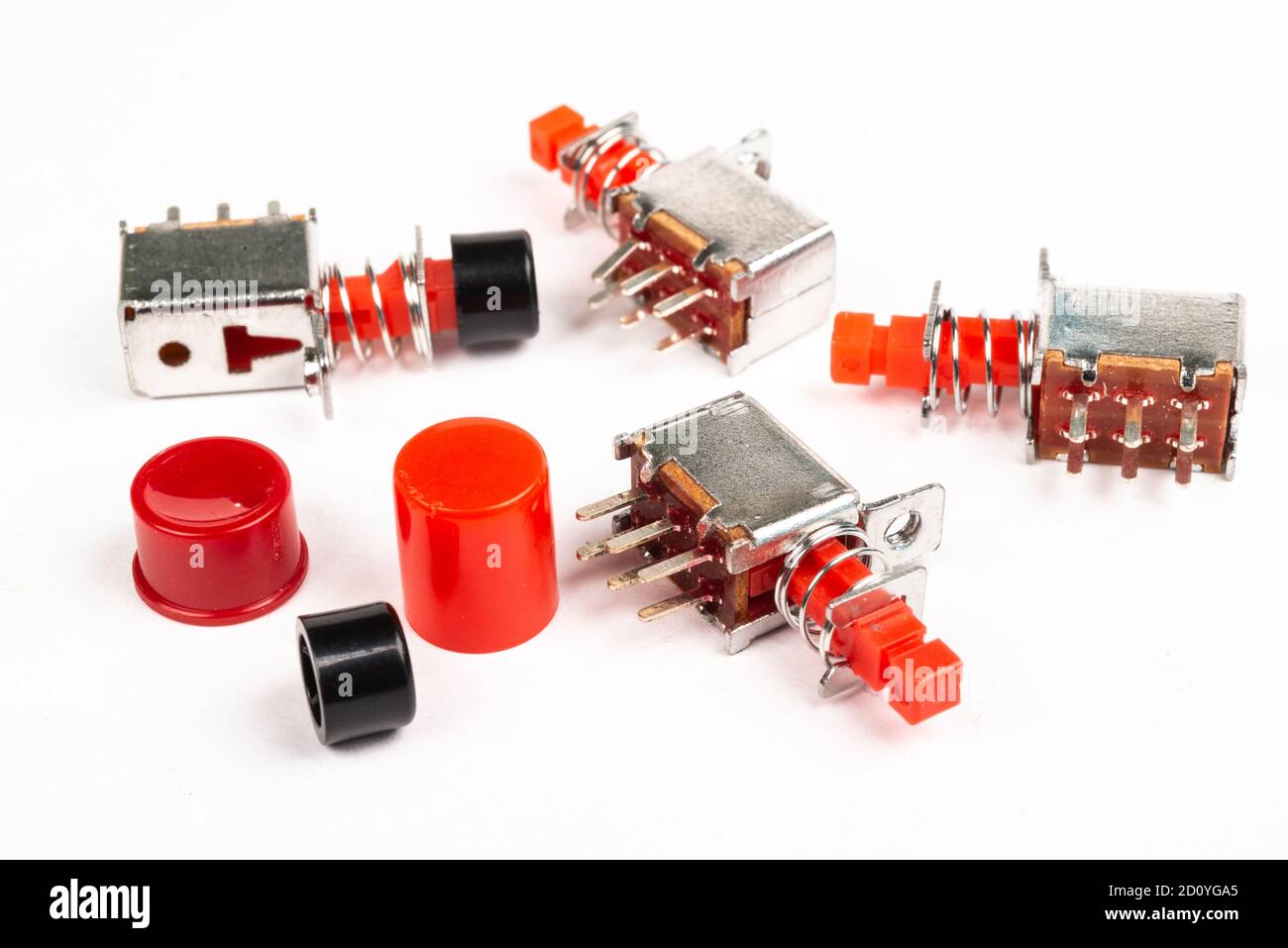 Miniature electric switches with red caps on isolated white background ...