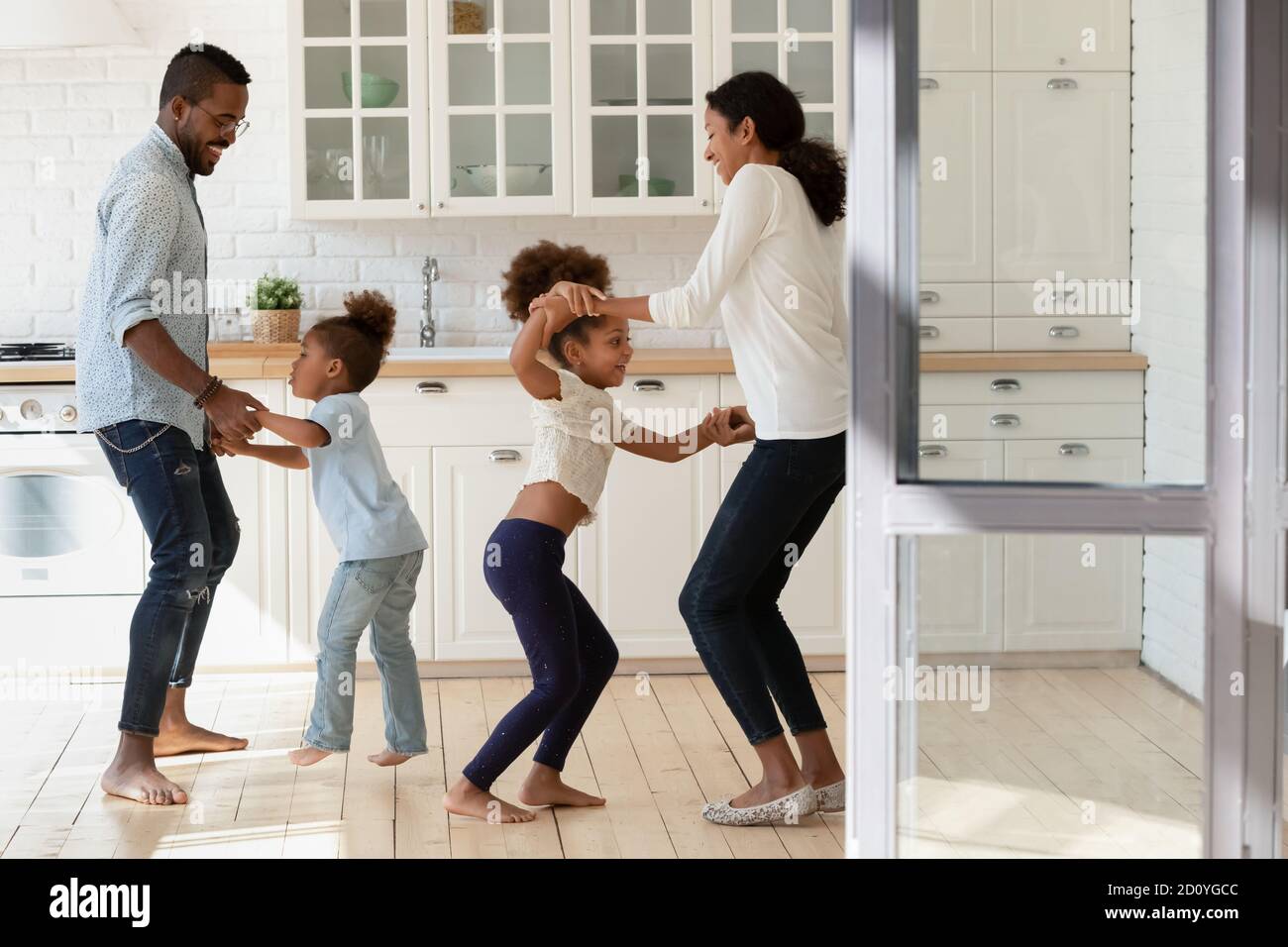 Active crazy african ethnicity family couple dancing with little ...