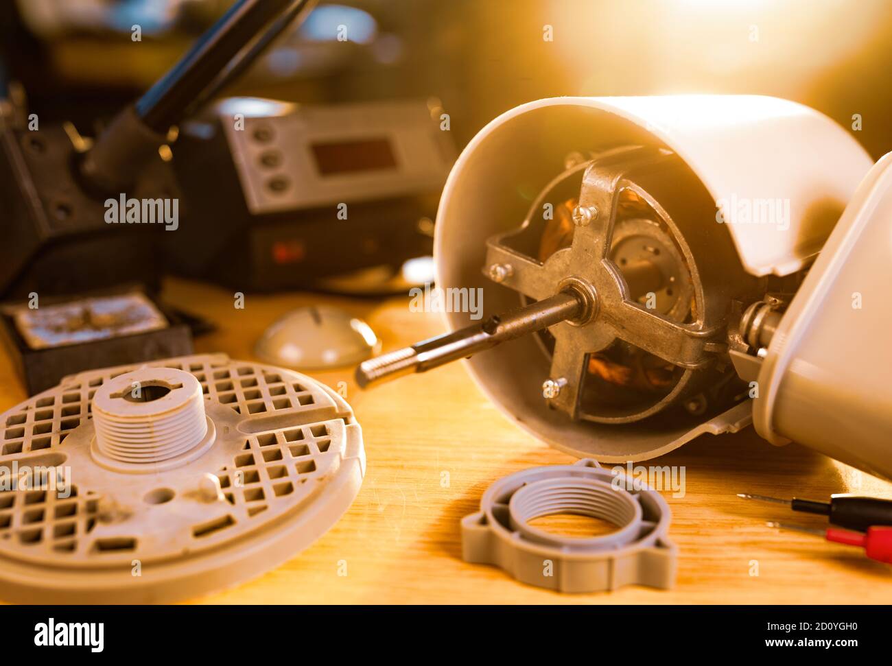 Close-up of an ironmotor from home cooling fan lies on a table during ...